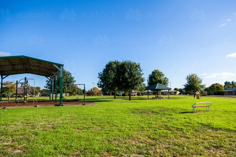 Image of Empty park with play equipment under shade - Austockphoto