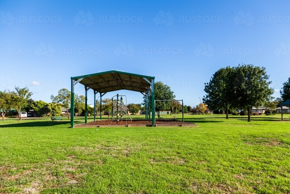 Image of Empty park with play equipment under shade - Austockphoto