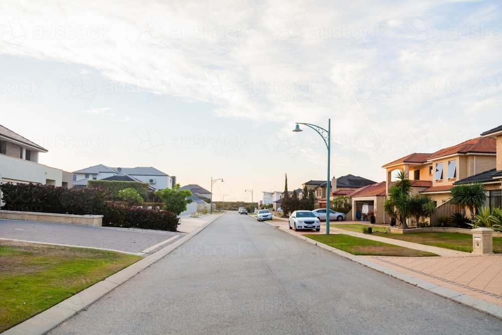 Image of Empty road with neat houses along it in coastal suburb ...