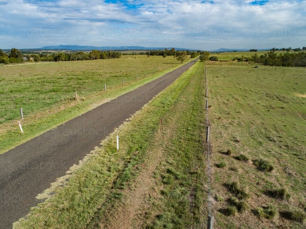 Image of Empty unmarked rural road - Austockphoto