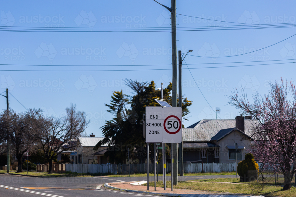 Image of end school zone 50 speed sign in town - Austockphoto