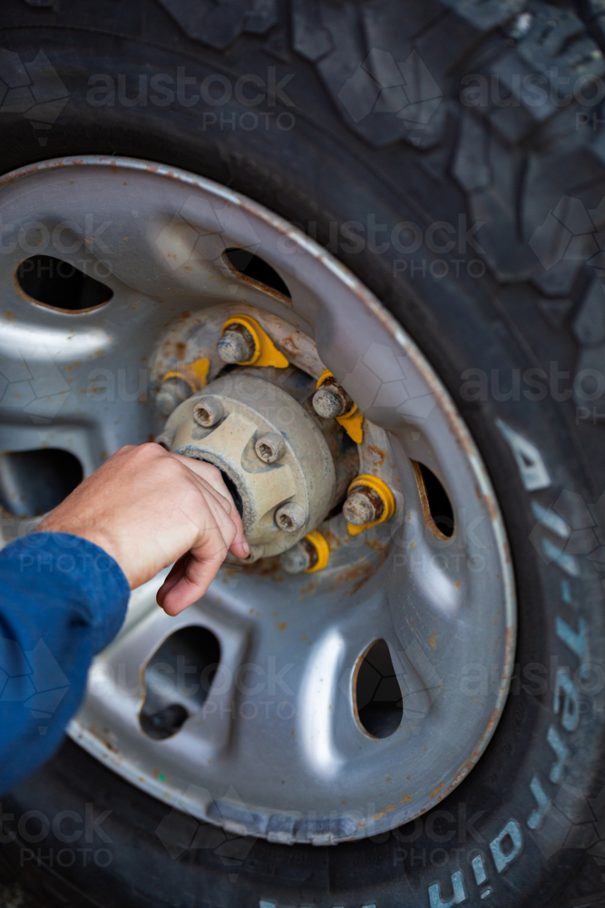 Image of engaging the hubs on a 4x4 ute wheel for off-roading ...