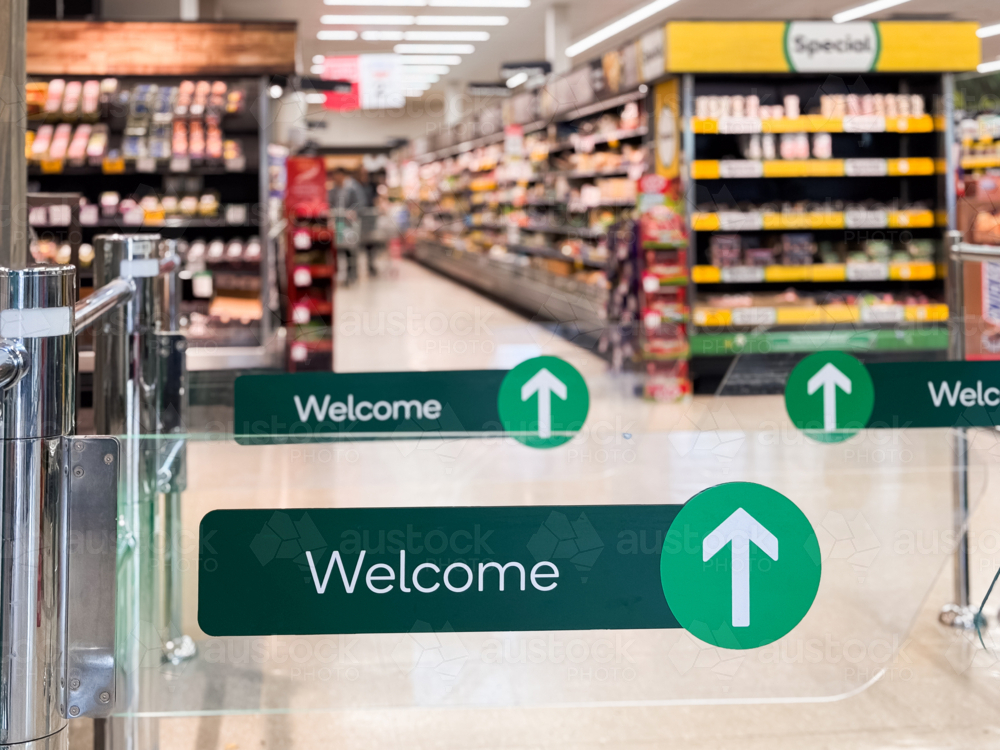 Image of entry to a supermarket with welcome signs and arrows ...