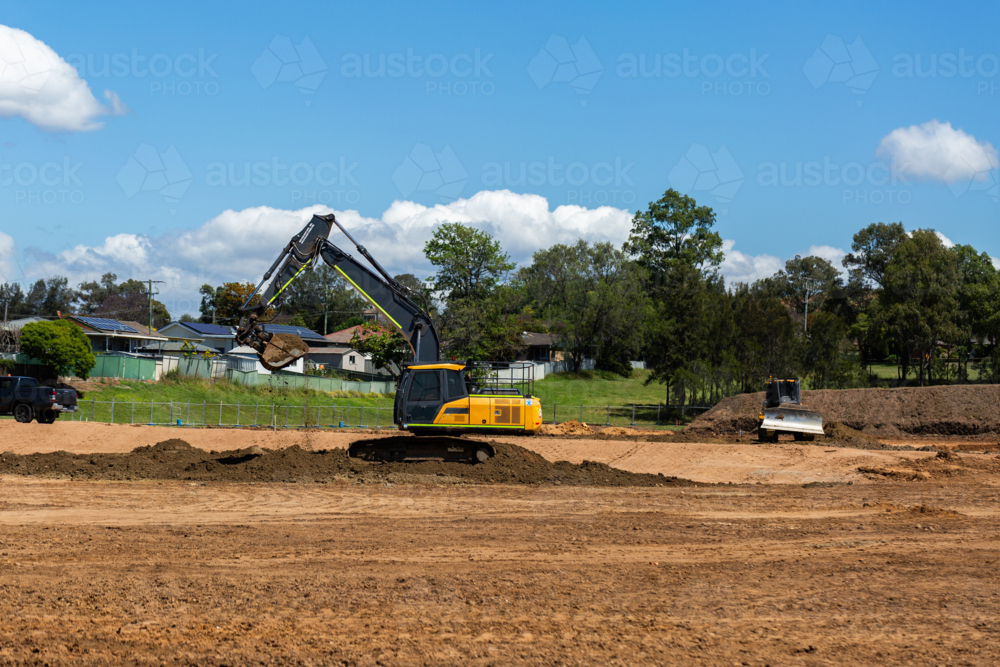 Image of Excavator digging dirt on construction site with earthmoving ...