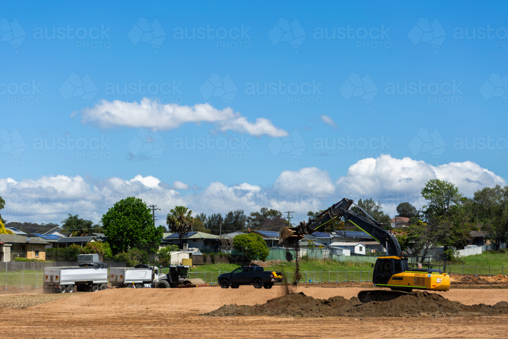 Image of Excavator digging dirt on construction site with earthmoving ...