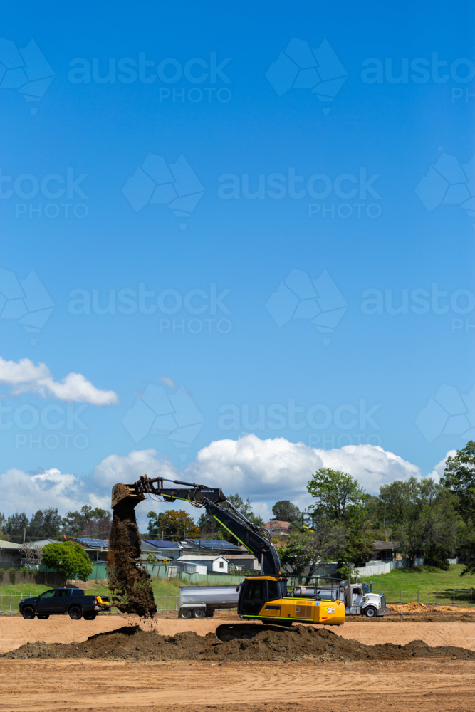 Image of Excavator digging dirt on construction site with earthmoving ...