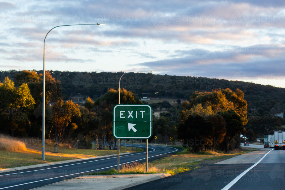 Image of Exit sign beside highway road at sunset in rural NSW Australia ...