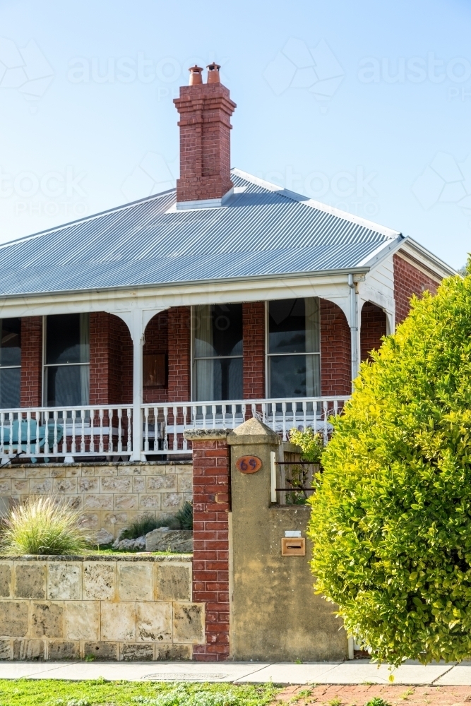 Image of Exterior of colonial style home with tin roof and chimney ...