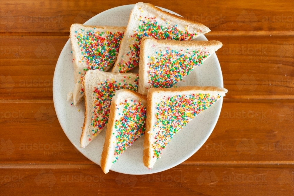 Image of Fairy bread party food on wooden table - Austockphoto
