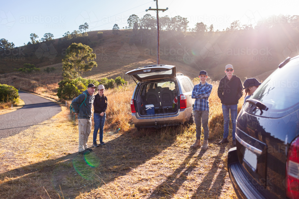Image of Family getting ready for bushwalk by cars at side of rural ...