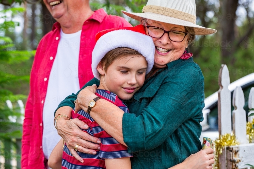 Image of family members hugging at Christmas family gathering ...