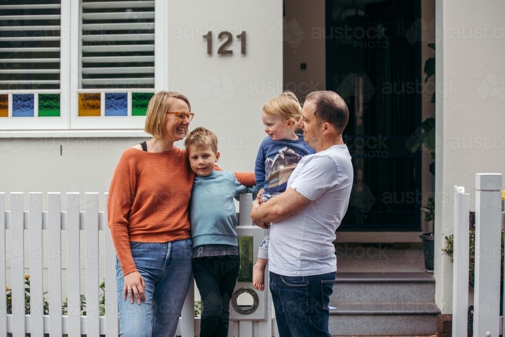 Image of Family standing together outside their home - Austockphoto