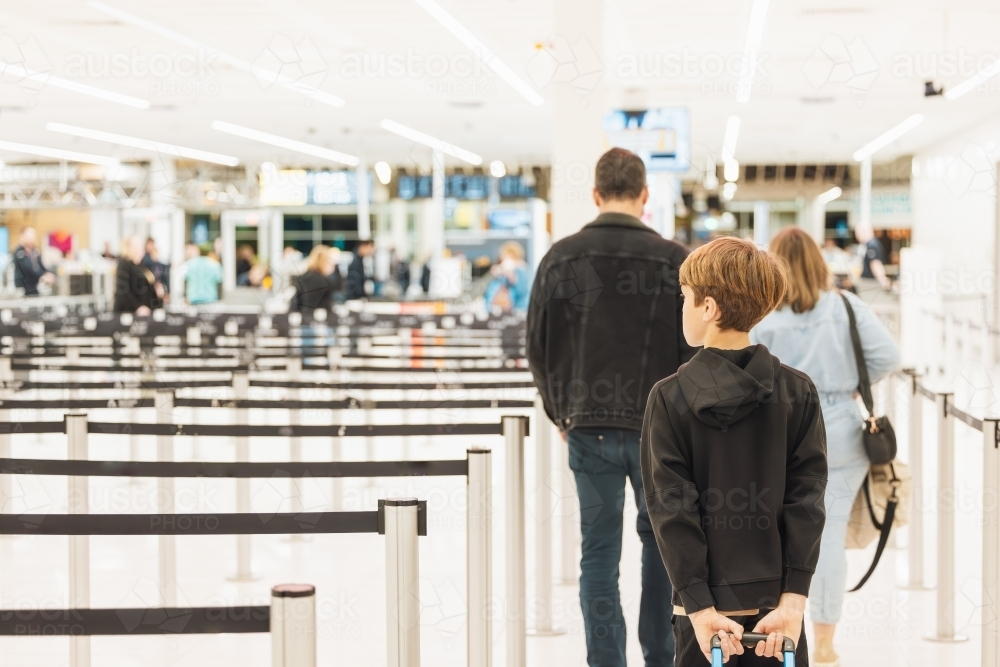 Image of Family walking through security screening at the airport ...