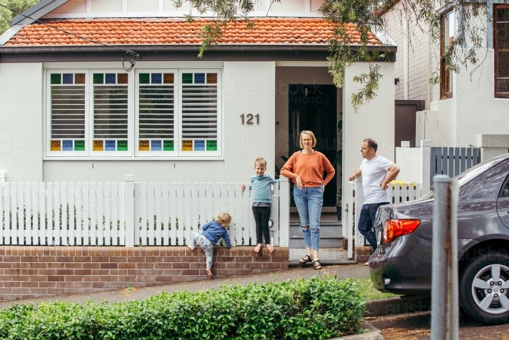 Image of Family with two parents and two children out the front their ...