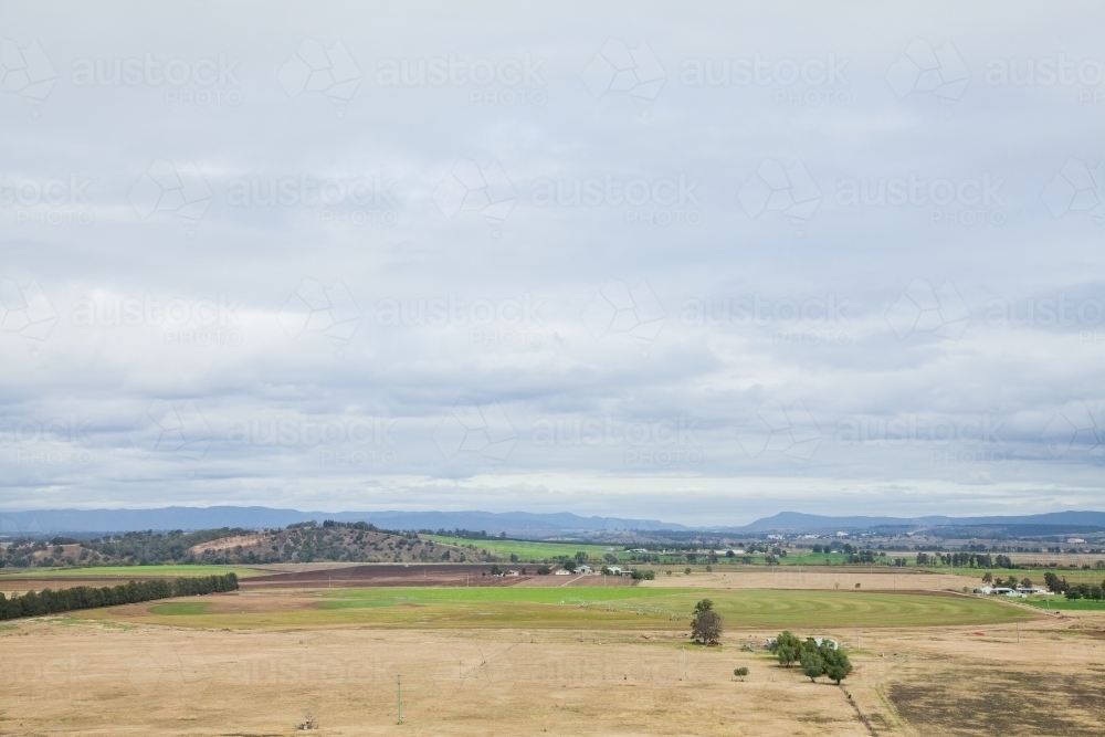 Image of Farm land in winter with overcast sky - Austockphoto