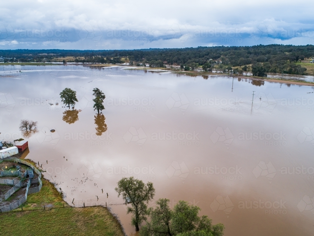 Image of Farm paddock with flood water up to cattle yard fence during ...