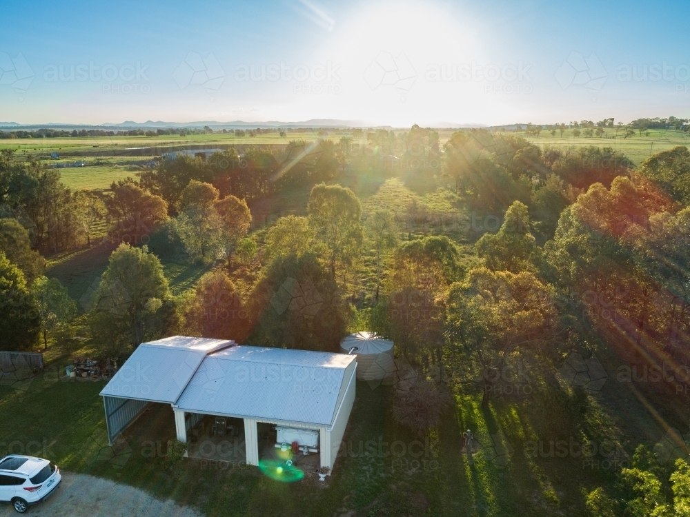 Image of Farm shed and tank amongst gum trees - Austockphoto