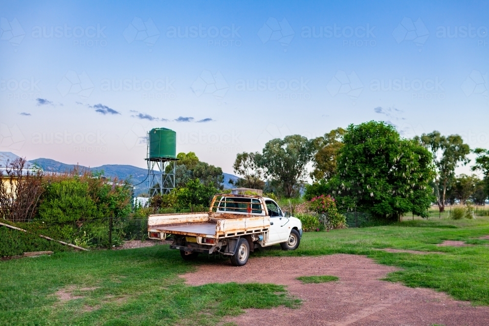 Image of Farm ute vehicle parked outside of homestead yard with water ...