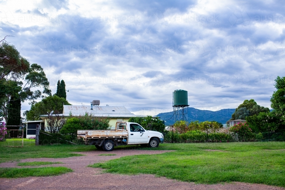 Image of Farm ute vehicle parked outside of homestead yard with water ...
