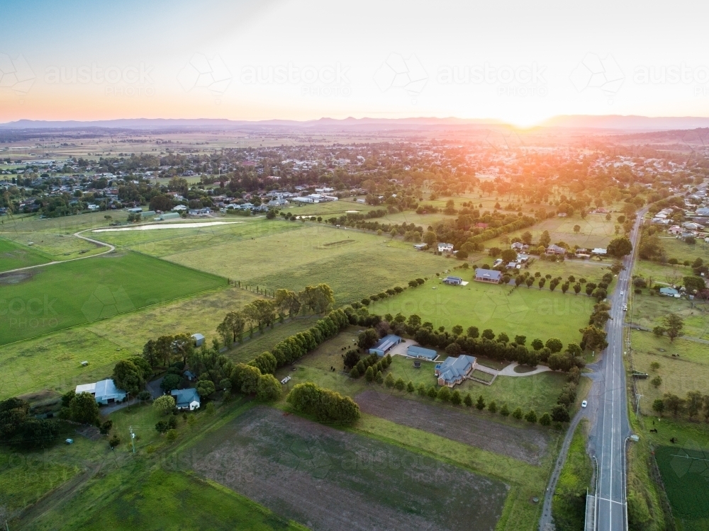 Image of Farmland and road into town with sun on horizon - Singleton ...