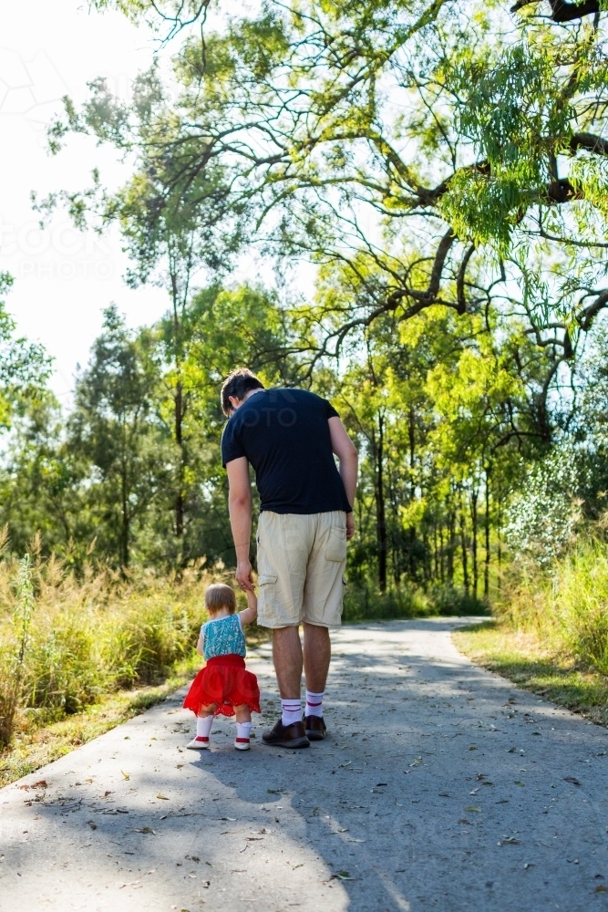 Image of Father and daughter walking along path - toddler walk with ...