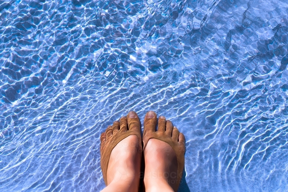 Image of Feet cooling off in cool clear water - Austockphoto
