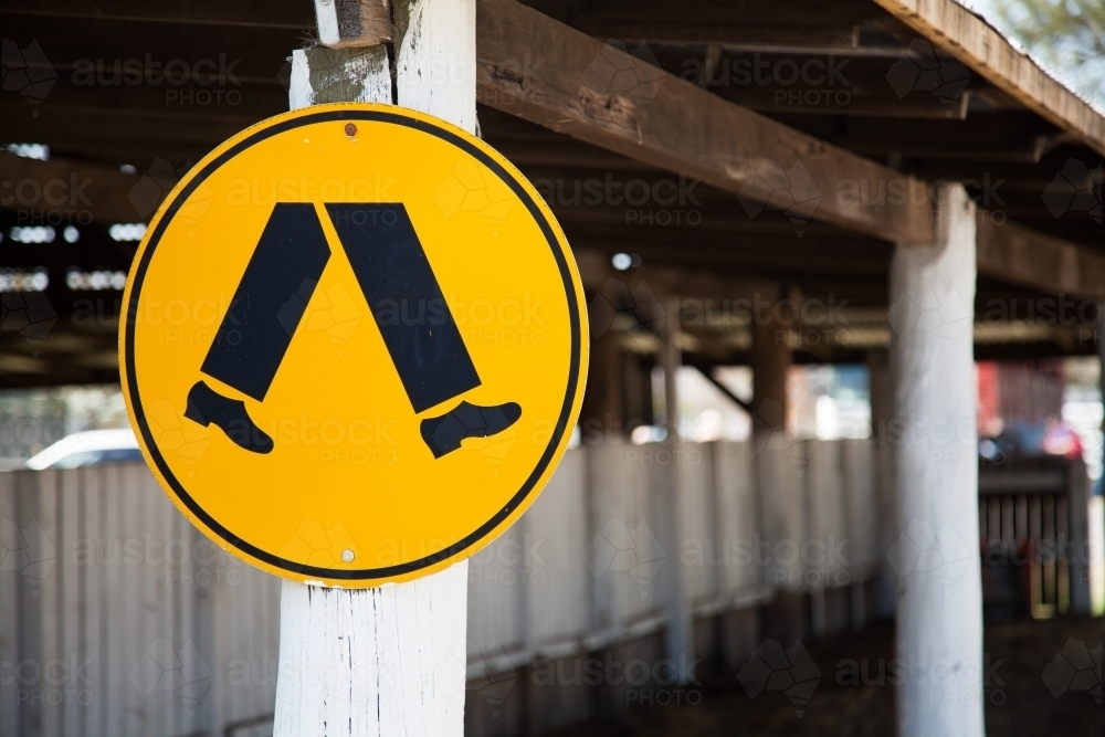 Image of Feet walking sign on post beside shed at showground - Austockphoto