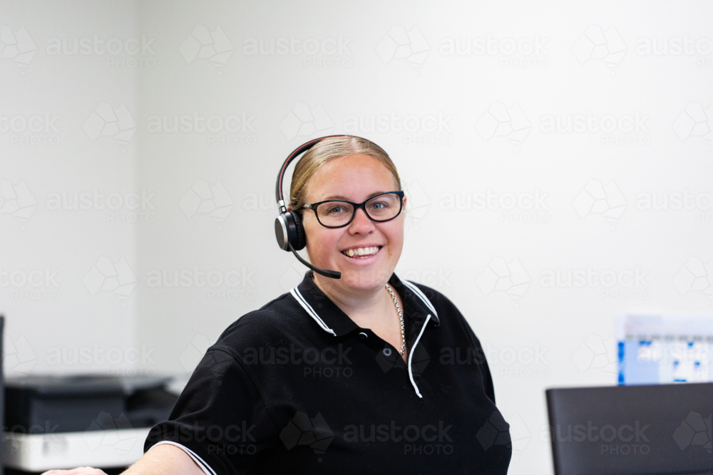 Image of female administrate staff lady sitting by computer at front ...