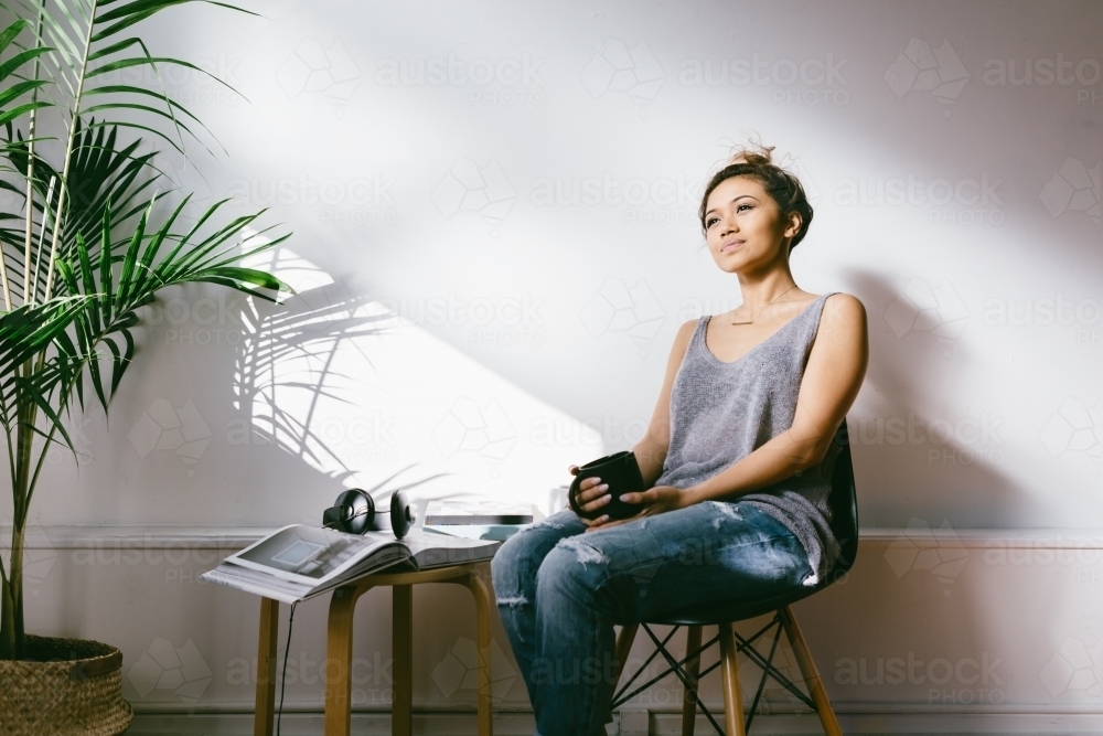 Image of Female at home with coffee contemplating life - Austockphoto