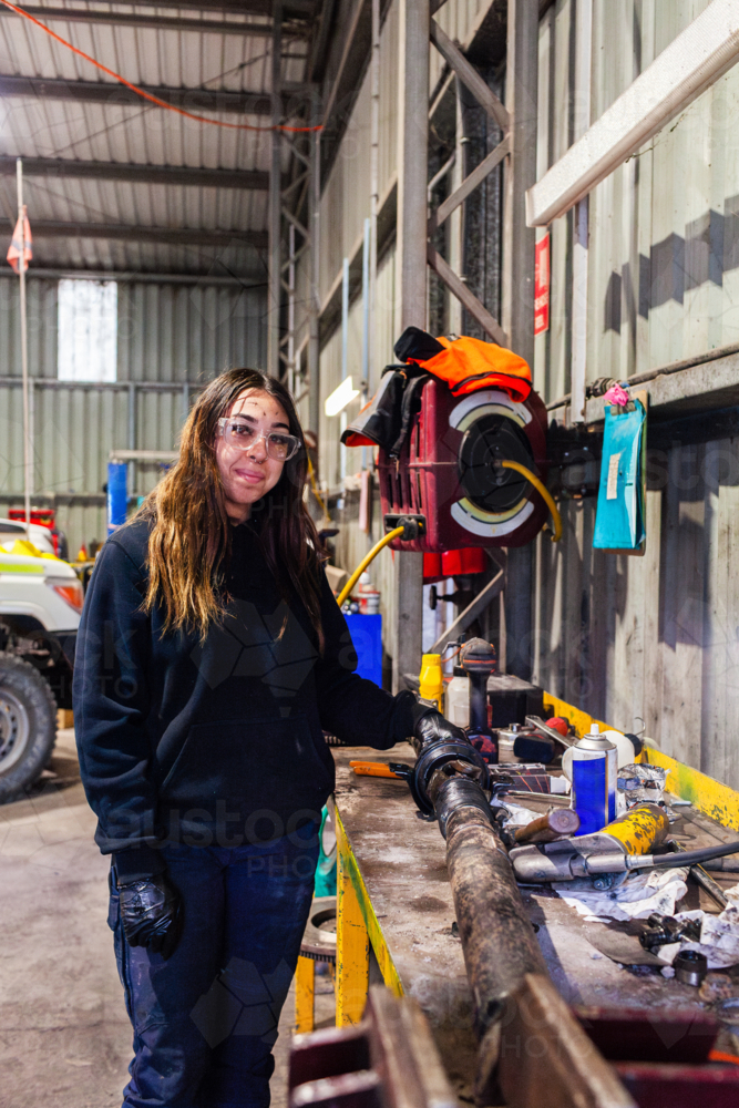 Image of Female Australian mechanic working on vehicle driveshaft joint ...