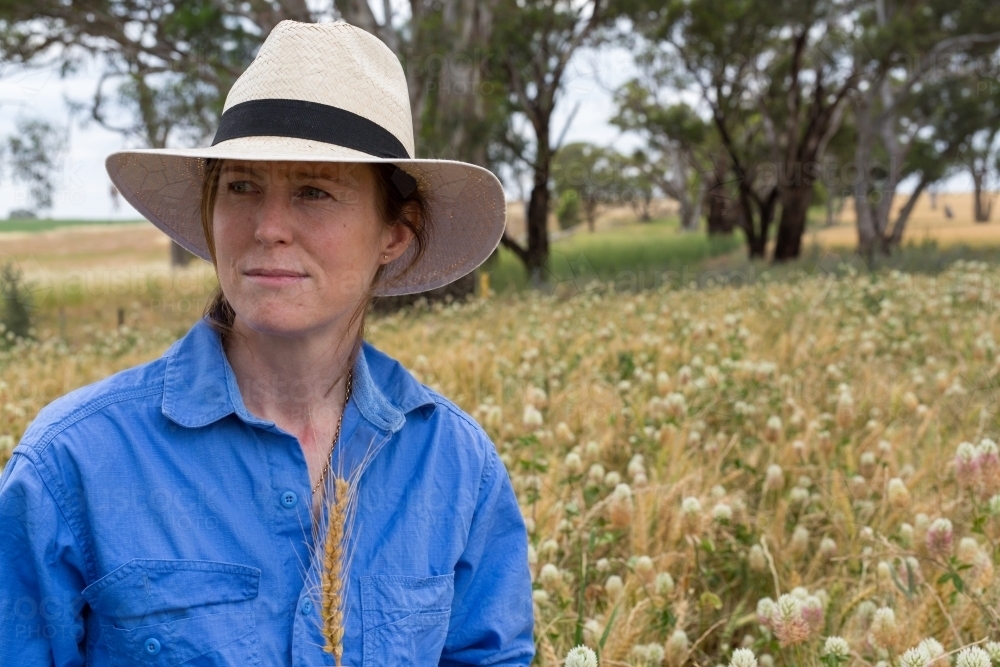 Image of Female farmer standing in a paddock - Austockphoto