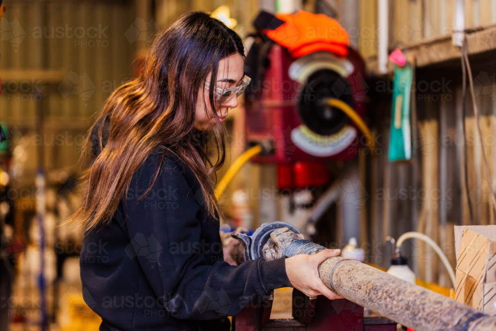 Image of Female mechanic checking and repairing vehicle drive shaft in ...