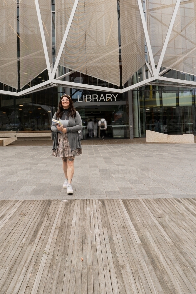 Image of Female Student in Front of Campus Building Walking Towards ...