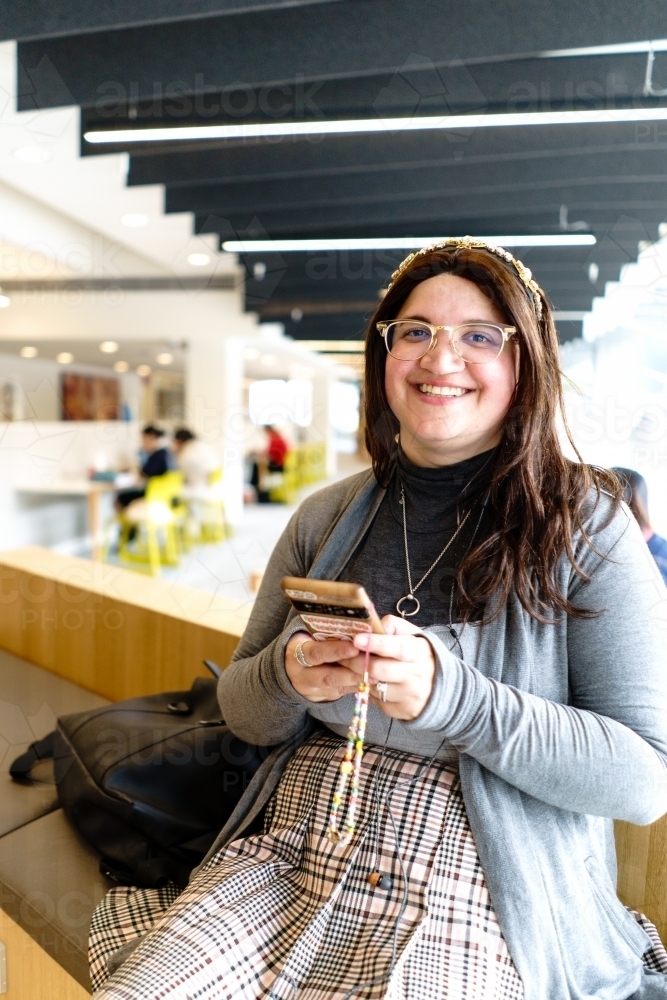 Image of Female Student Smiling Inside Campus Building - Austockphoto