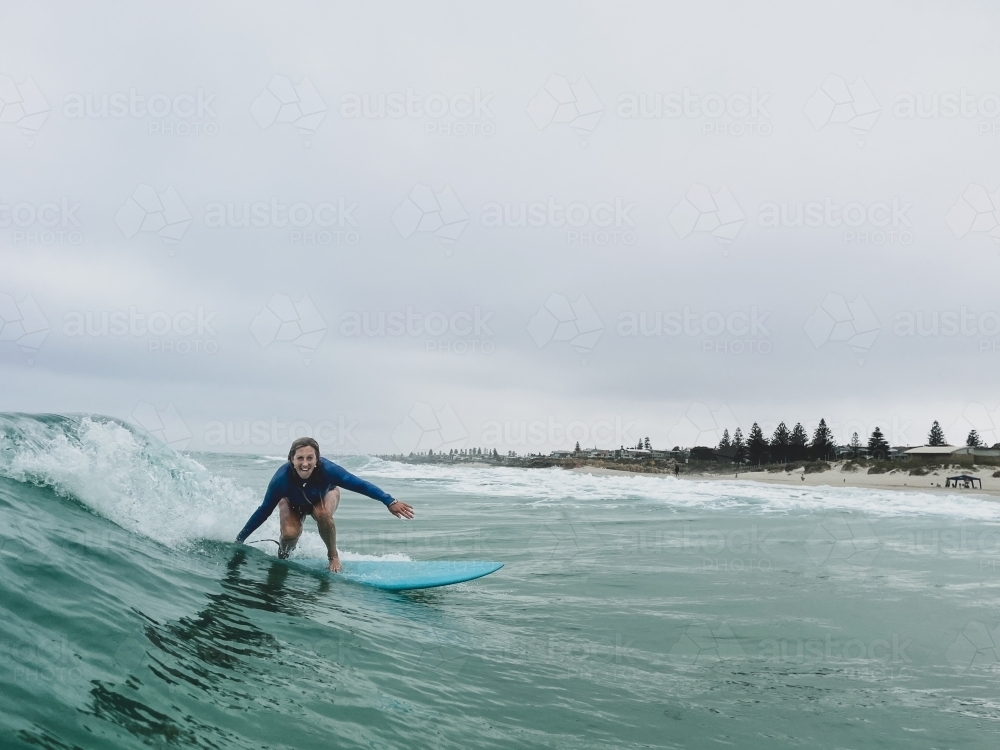 Image of Female woman surfer surfing a longboard on wave looking ...