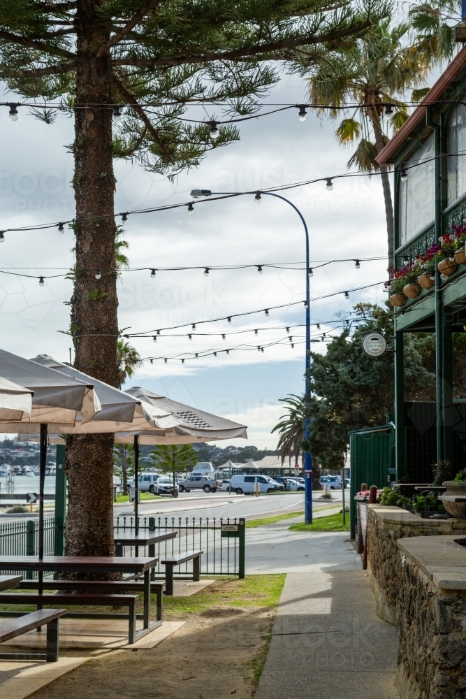 Image of Festoon lights outside a bar and cafe. - Austockphoto
