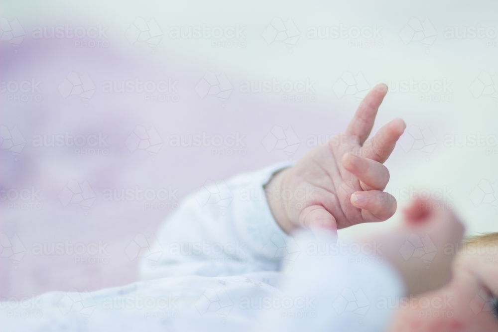 Image of Fingers and hand of a newborn baby reaching out - Austockphoto