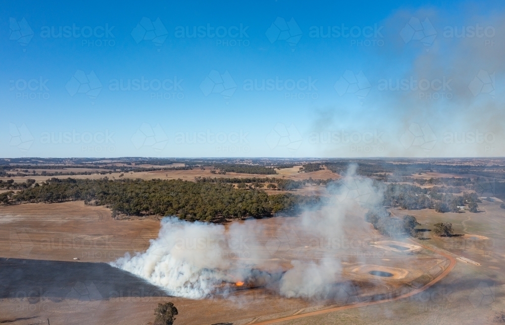 Image of fire burning stubble of farm during controlled burn - Austockphoto