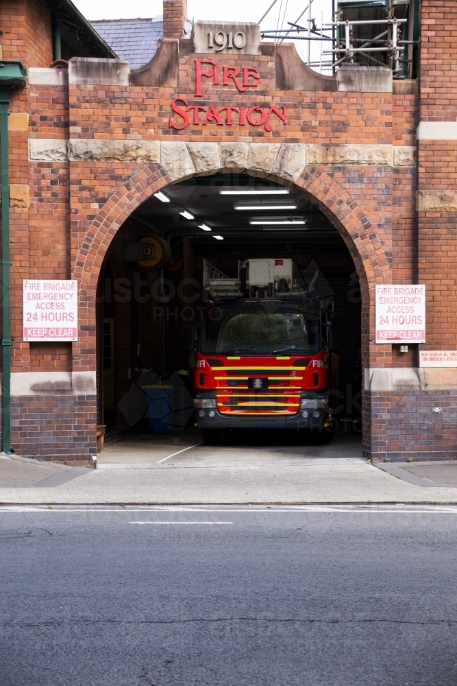 Image of fire truck in fire station, vertical - Austockphoto