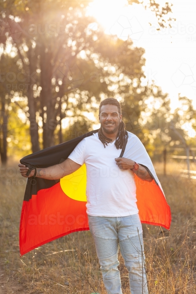 Image of First Nation Australian man standing with Aboriginal flag in ...