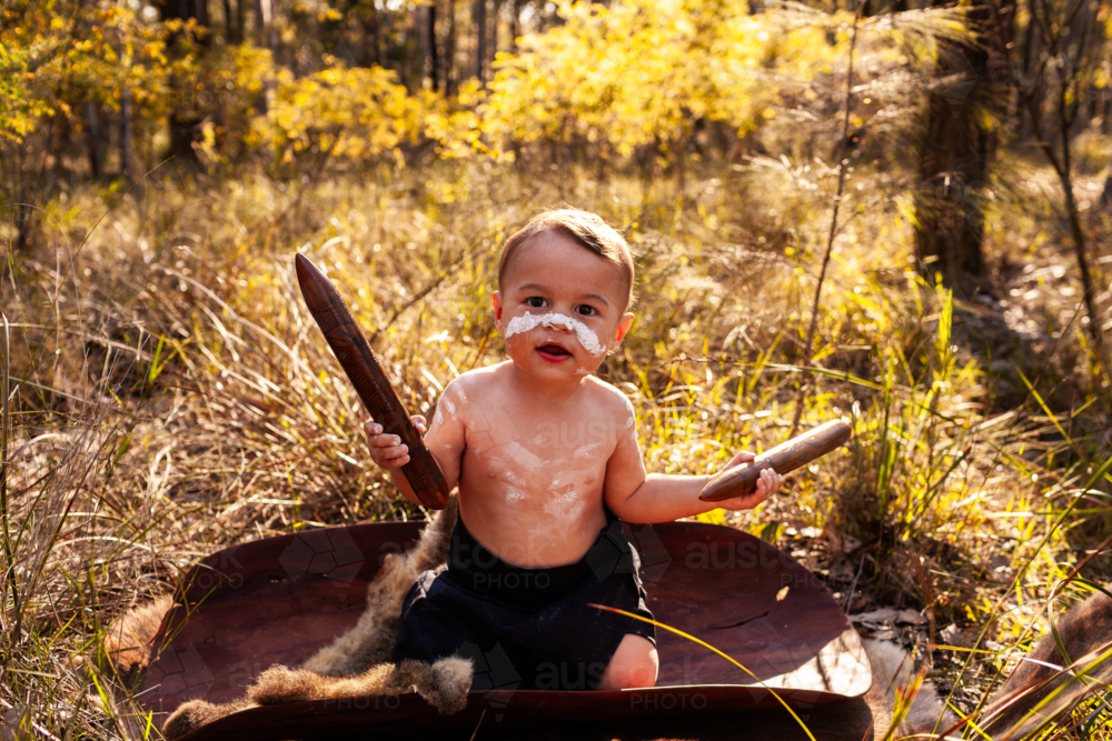 Image of First Nations Australian boy in coolamon among grass in ...