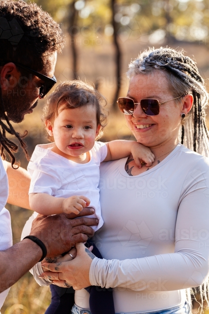 Image of First nations Australian family with baby girl - Austockphoto
