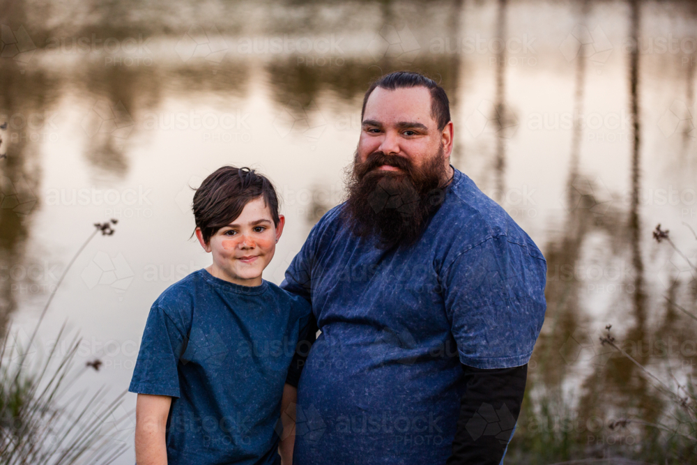 Image of First nations Australian father and son standing together by ...