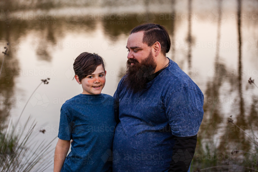 Image of First nations Australian father and son standing together by ...