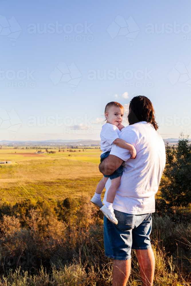Image of First Nations Australian father holding young Aboriginal son ...