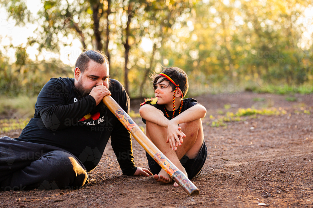 Image of First Nations Australian father teaching Aboriginal son to ...