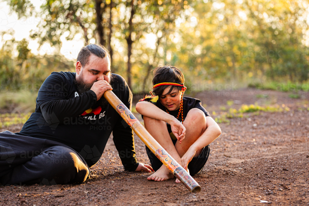 Image of First Nations Australian father teaching Aboriginal son to ...
