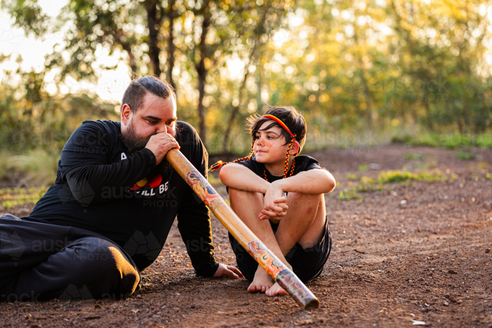 Image of First Nations Australian father teaching Aboriginal son to ...
