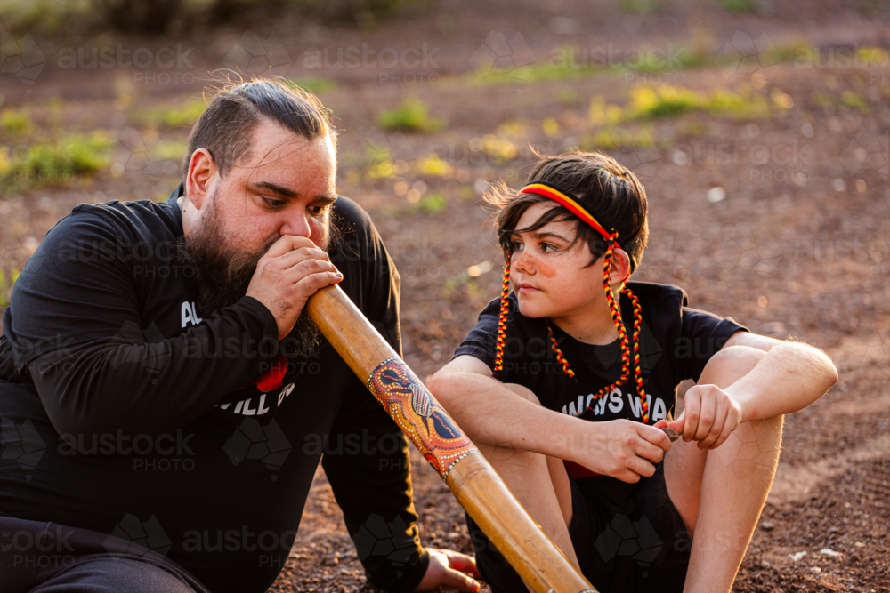 Image of First Nations Australian father teaching Aboriginal son to ...