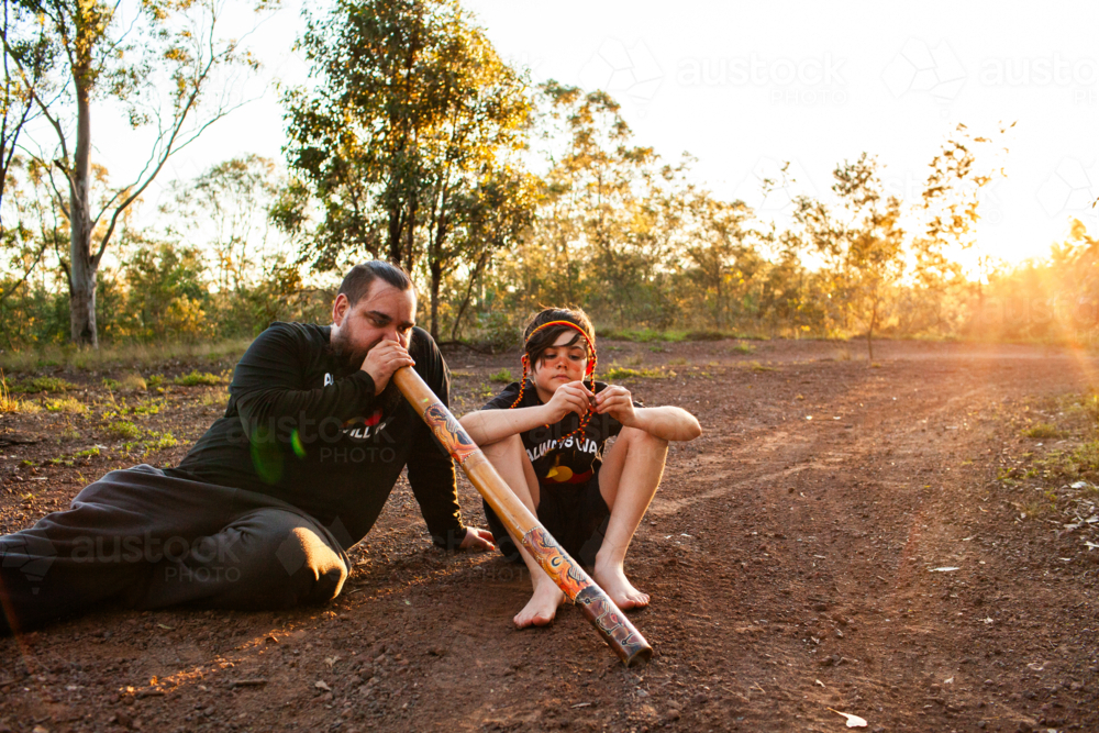 Image of First Nations Australian father teaching Aboriginal son to ...